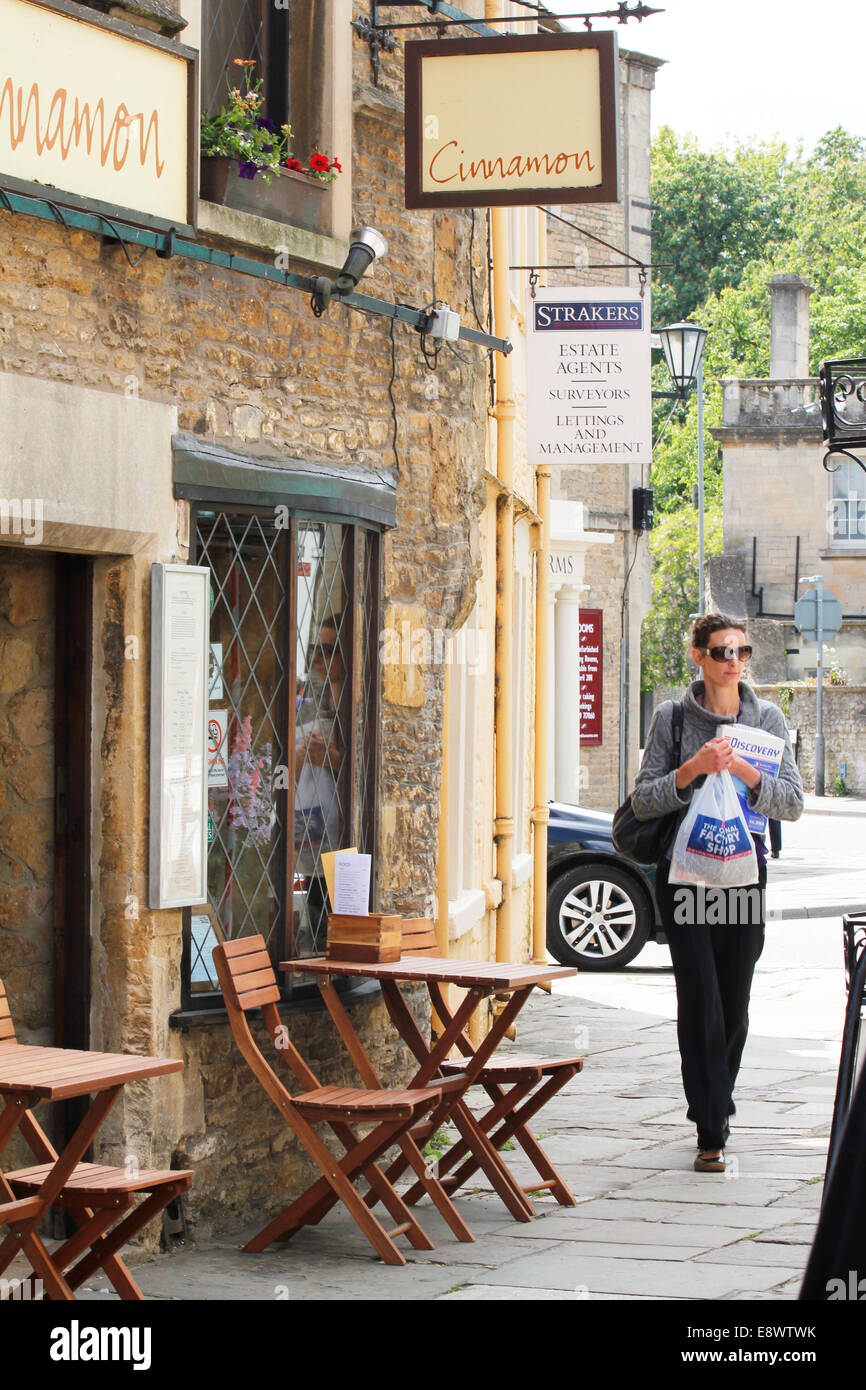 Woman walking in front of cafe in The Coppins, Corsham, Wiltshire ...
