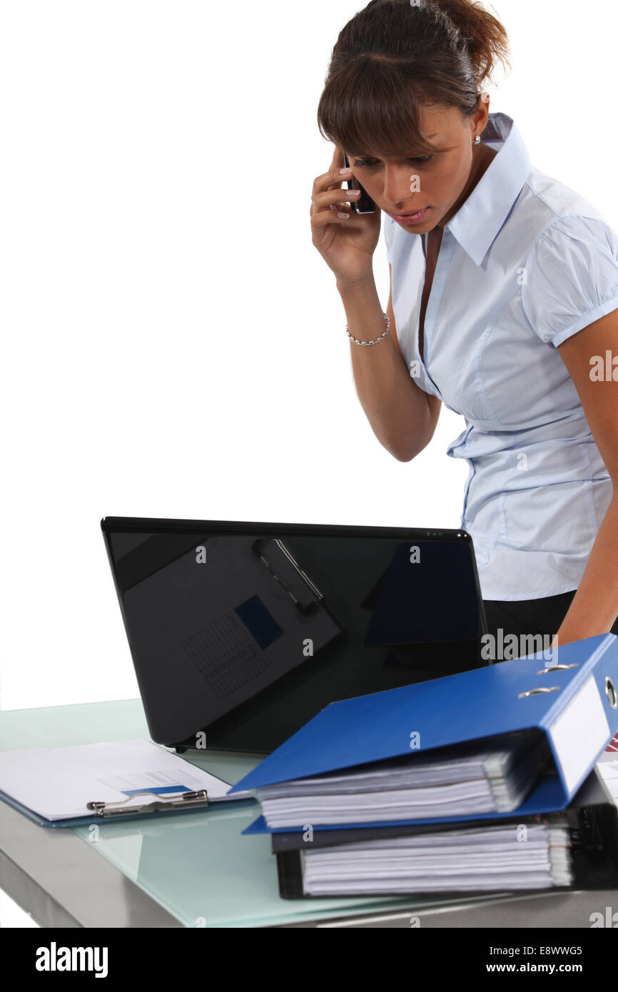 Busy female office worker Stock Photo - Alamy