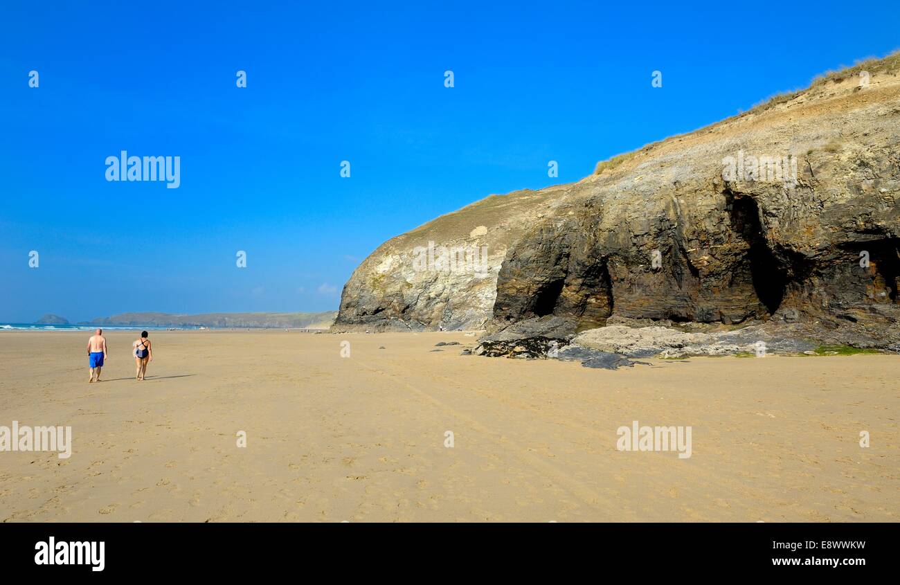 A couple walking along Penhale Sands Perranporth Beach Cornwall England ...