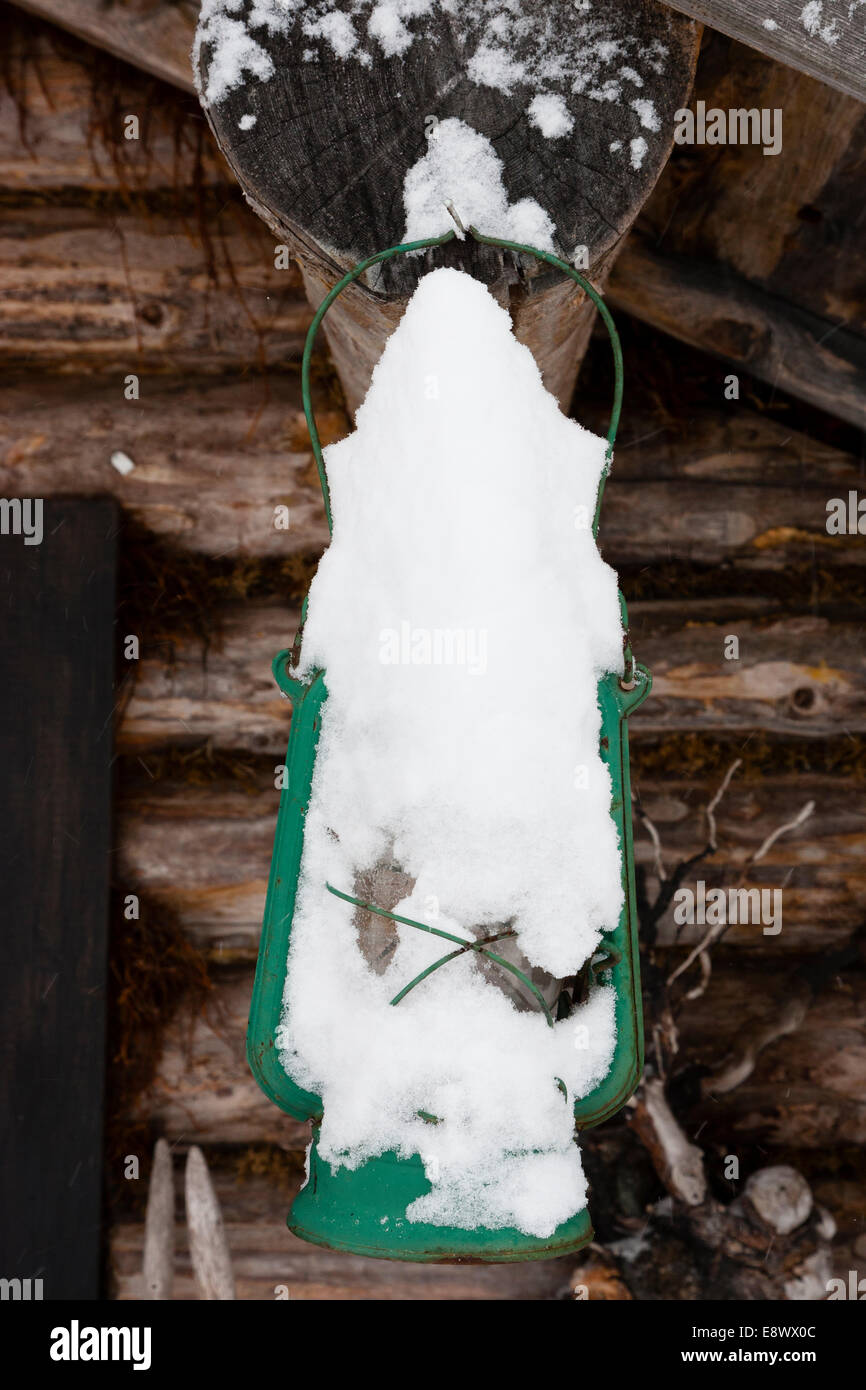 JAVRE, SWEDEN Green lantern hanging from log cabin in snow Stock Photo ...