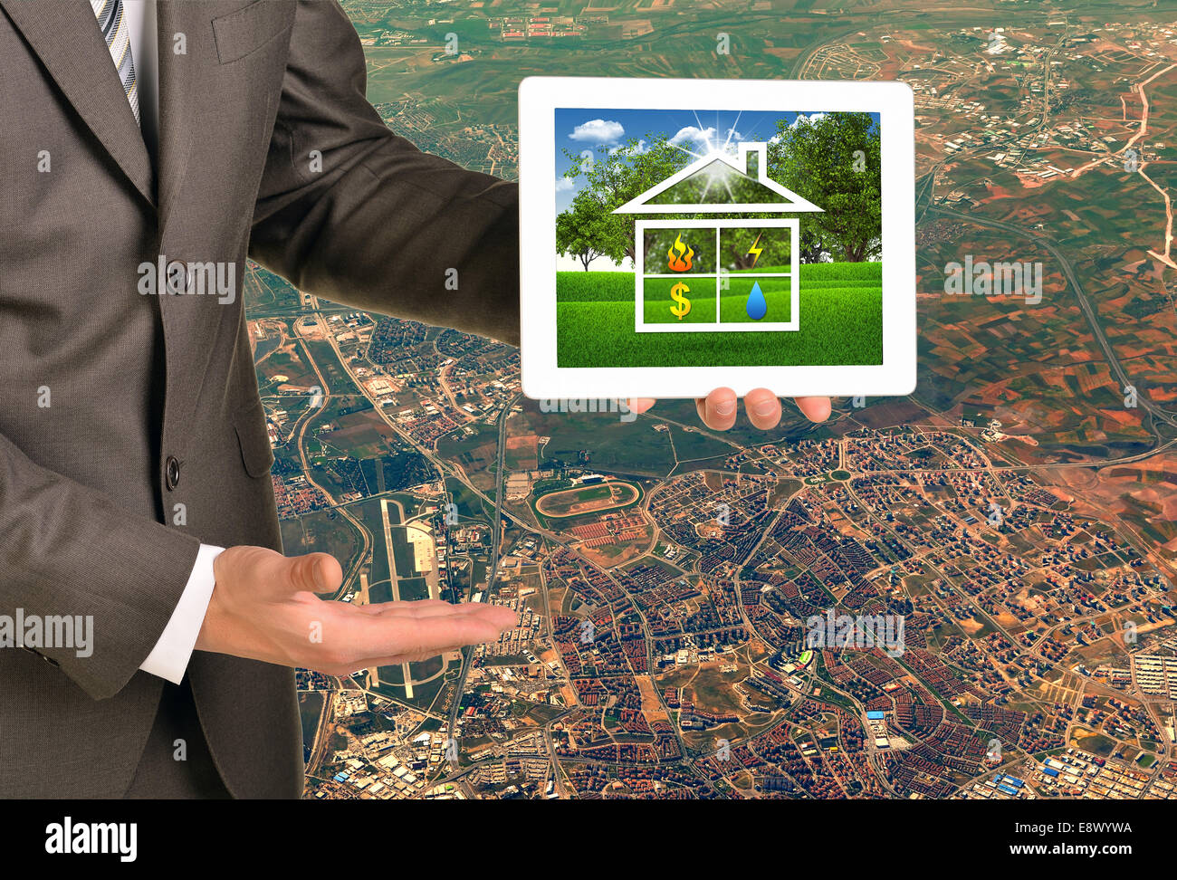 Hands holding tablet pc with image icon home on screen Stock Photo - Alamy