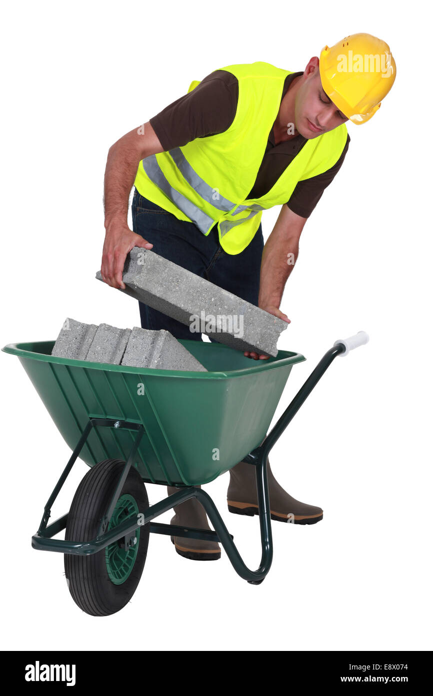 Worker with a wheelbarrow Stock Photo - Alamy