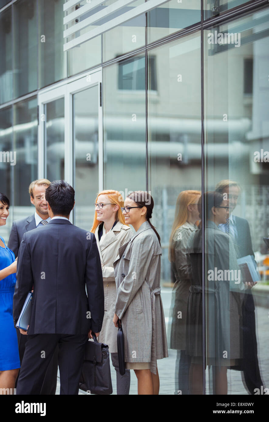 Business people talking outside office building Stock Photo - Alamy
