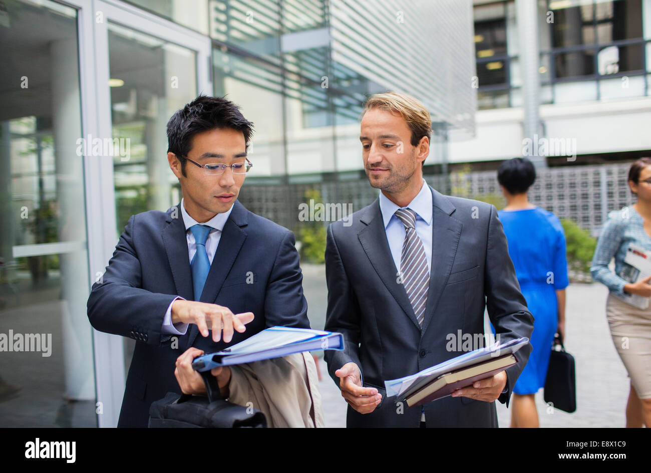 Businessmen talking outside of office building Stock Photo - Alamy