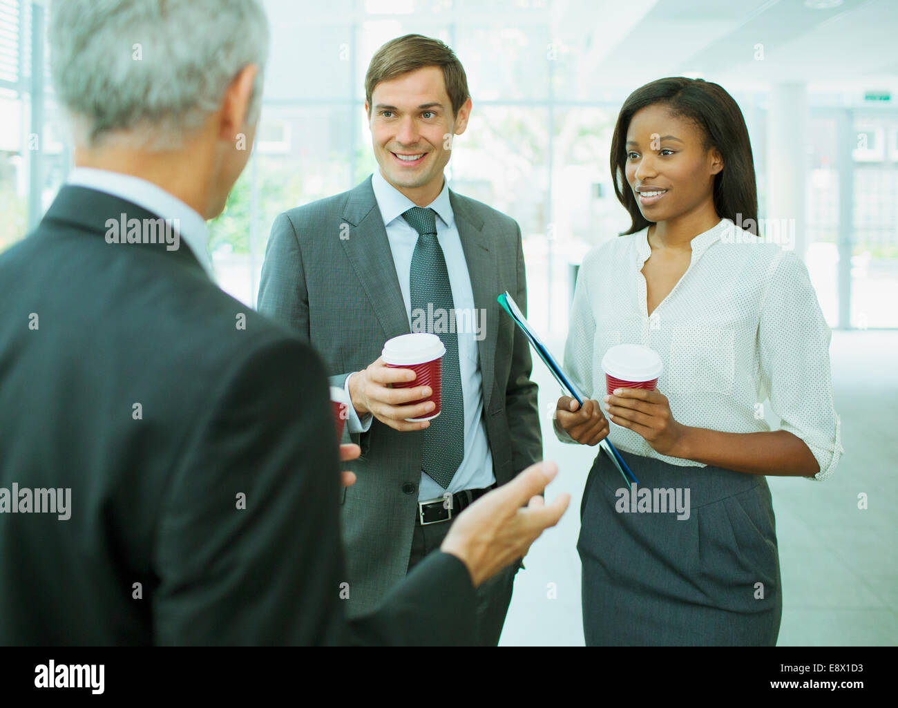 Business people talking in office building Stock Photo - Alamy