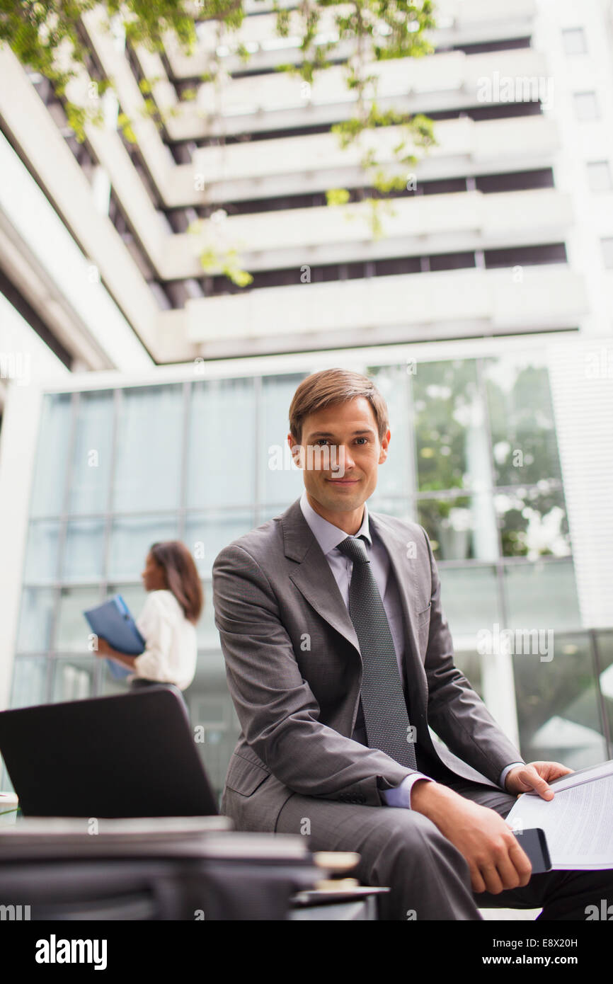 Businessman working on bench outside of office building Stock Photo - Alamy
