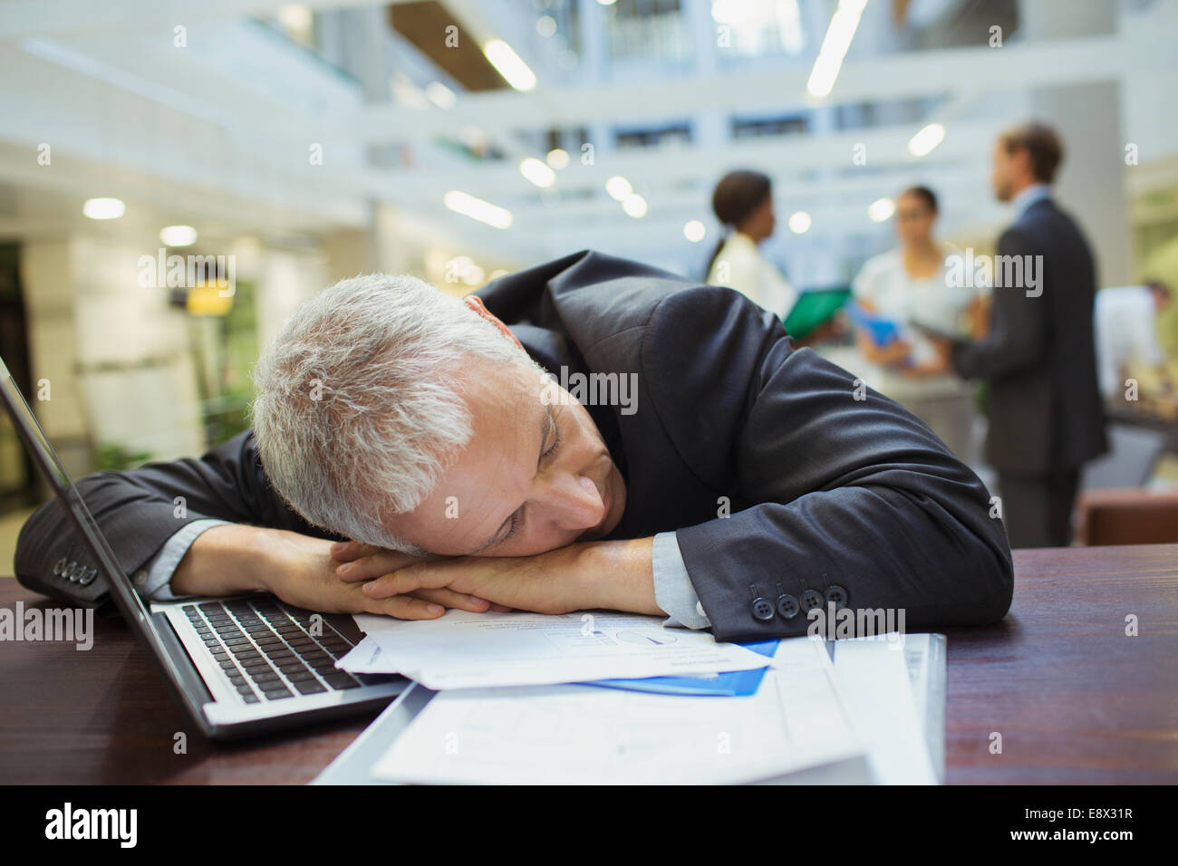 Businessman resting in office building Stock Photo - Alamy