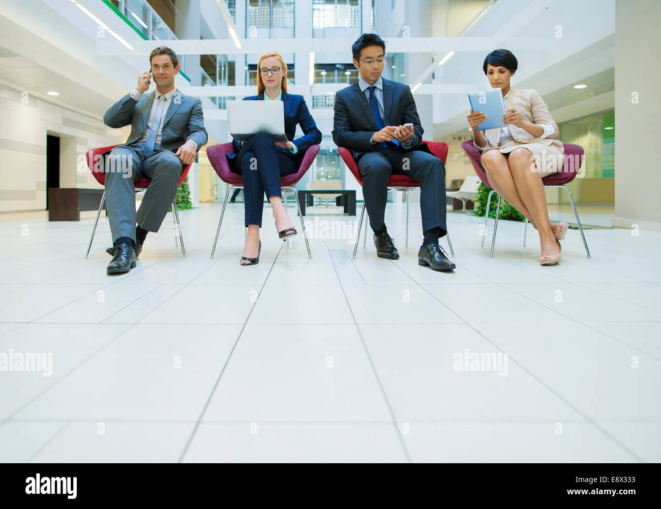 Business people sat in chairs working in office building Stock Photo ...