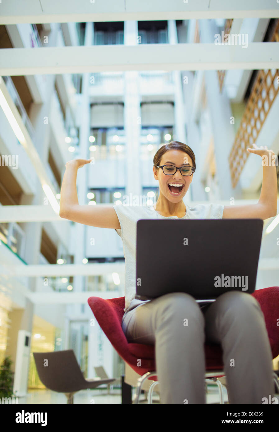 Businesswoman getting excited in office building Stock Photo - Alamy