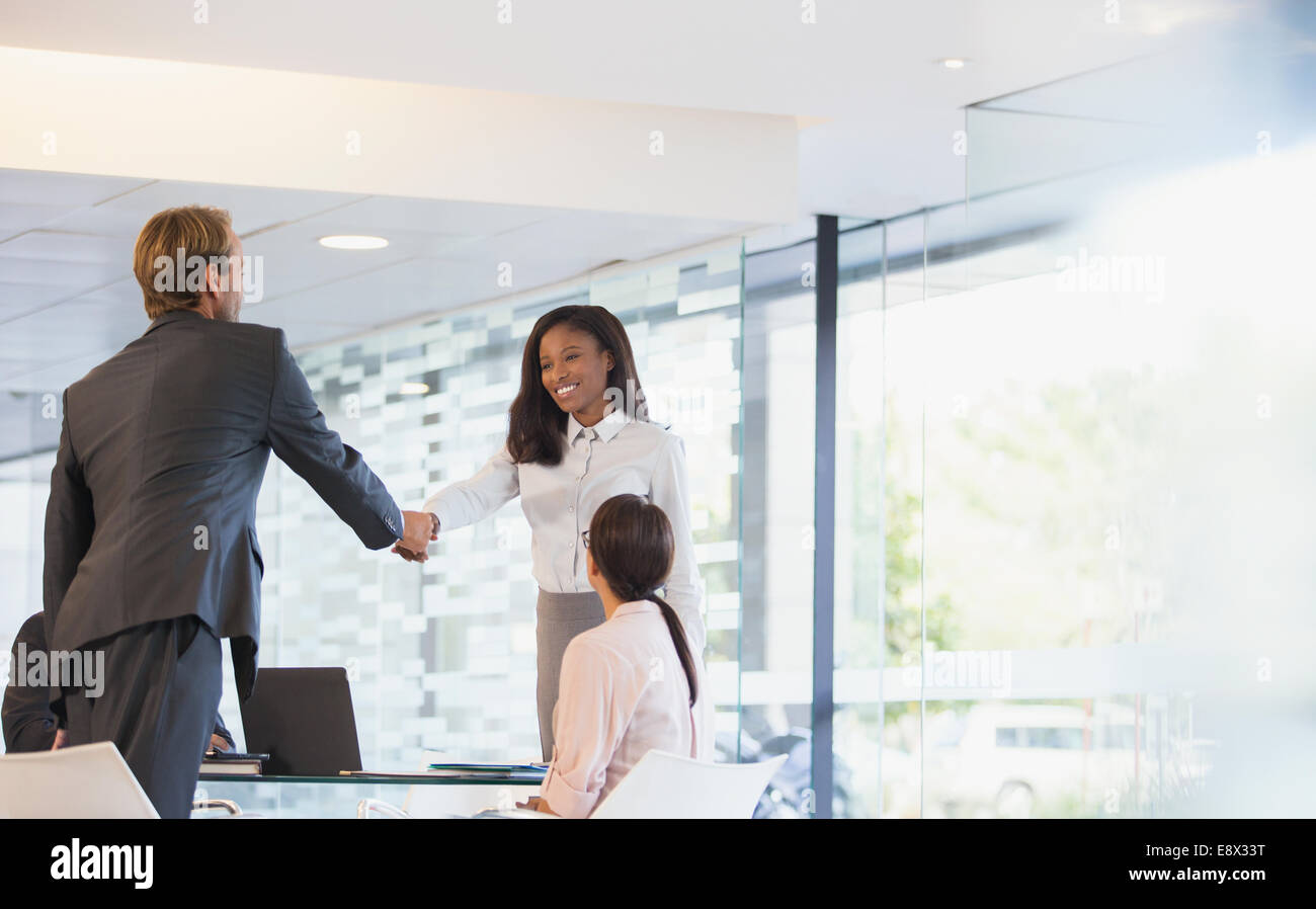 Business people shaking hands in office building Stock Photo - Alamy