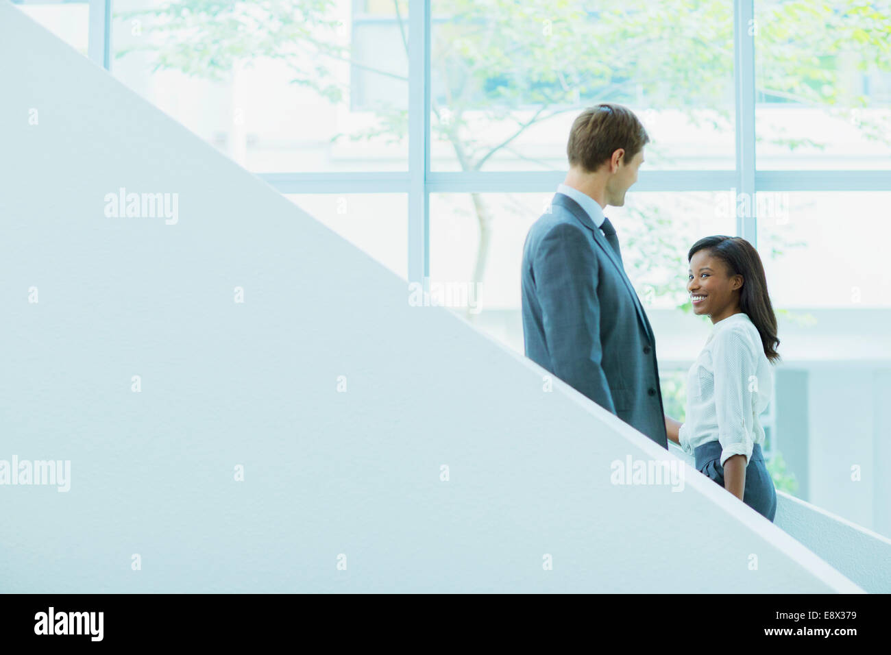 Business people crossing paths on staircase Stock Photo - Alamy