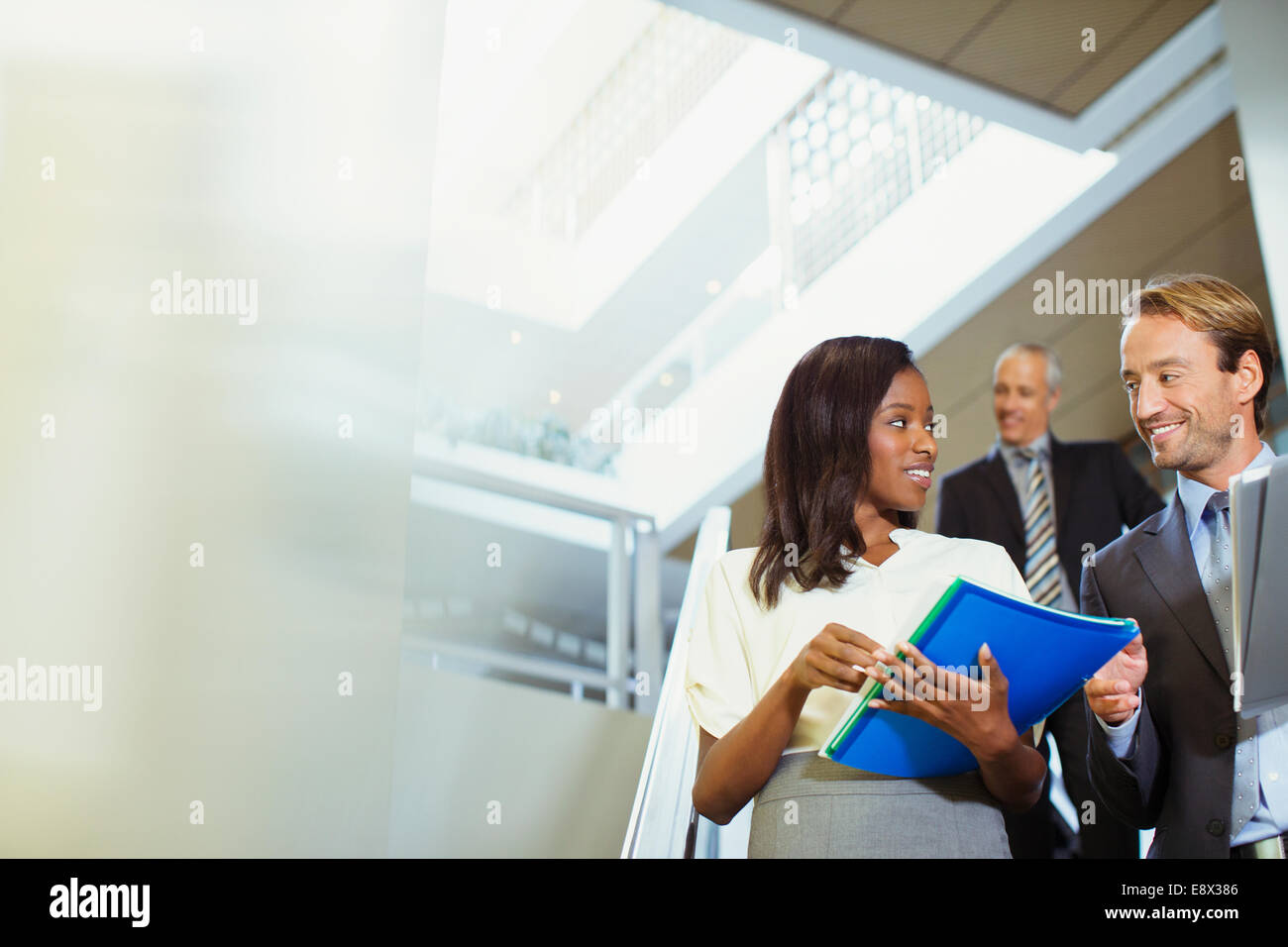 Business people talking in office building Stock Photo - Alamy