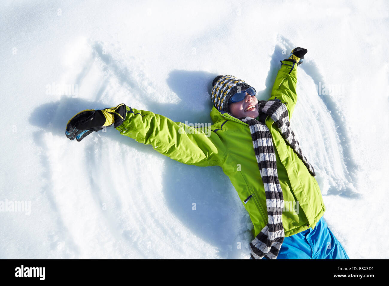 Man making snow angle Stock Photo - Alamy