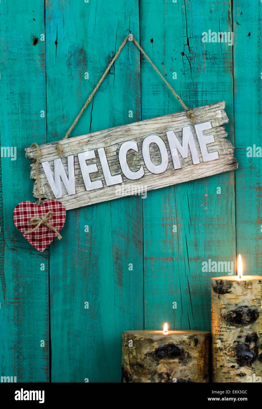Wooden welcome sign with red plaid heart and burning candles hanging on ...