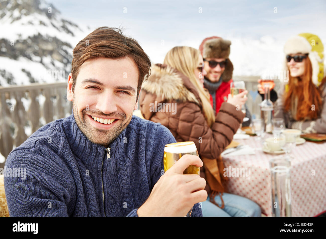 Man enjoying drinks with friends Stock Photo - Alamy