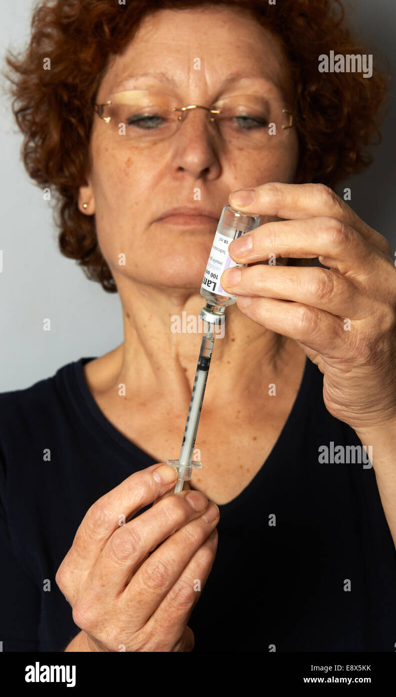 Woman drawing-up an insulin injection Stock Photo - Alamy