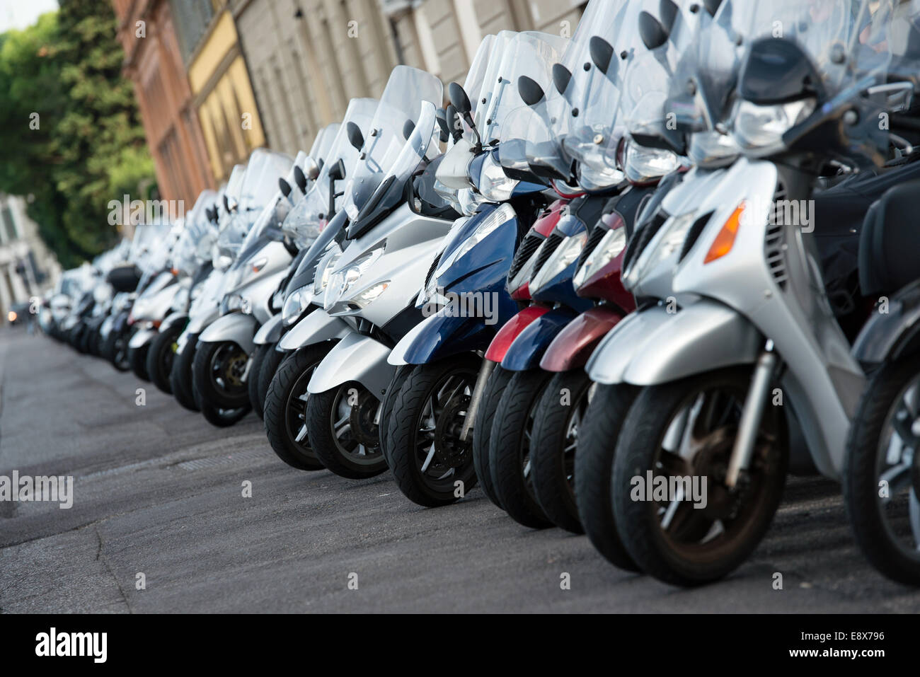 a lot of motor scooters parked in a row Stock Photo - Alamy