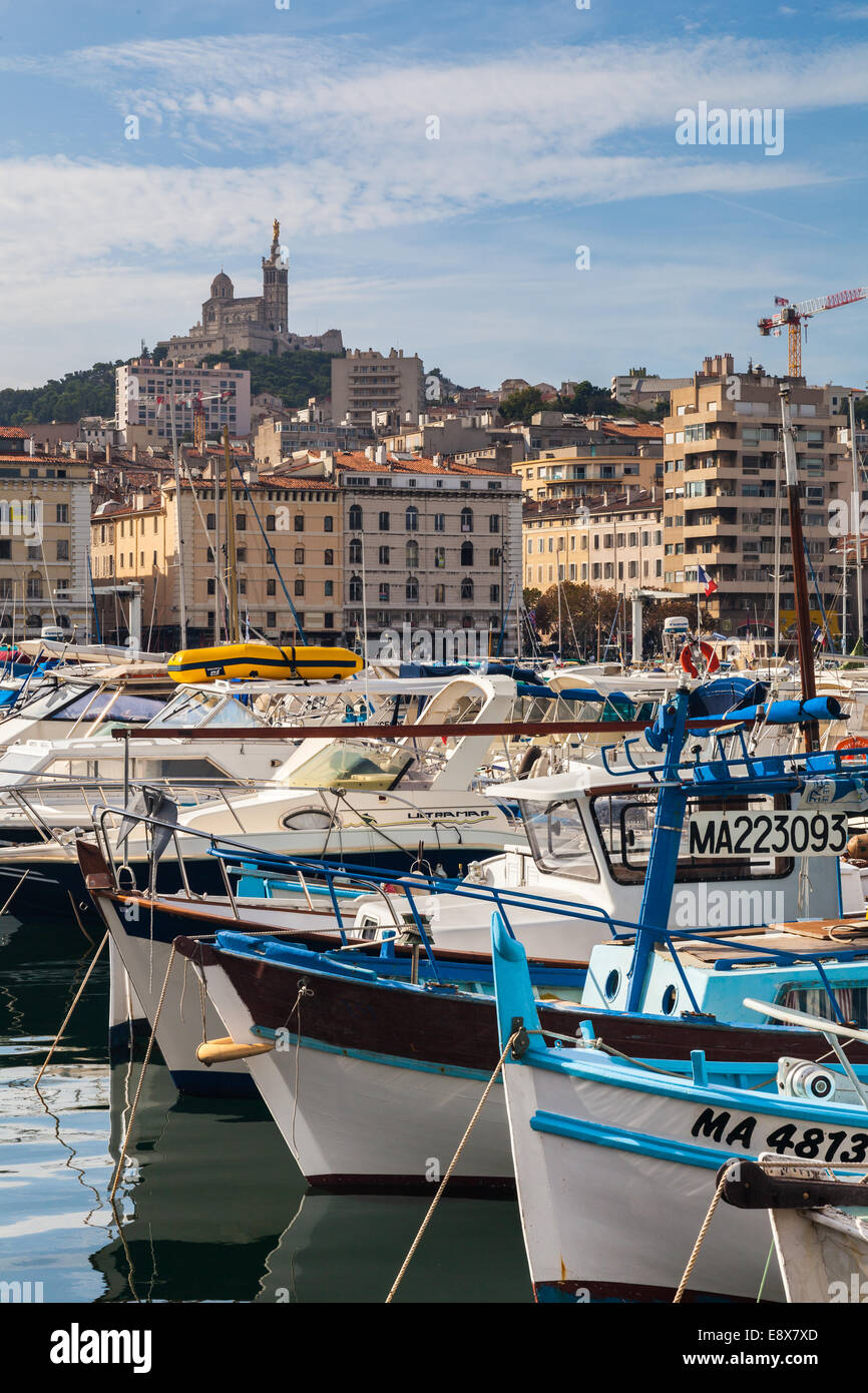 Fishing boats in the Old Port of Marseille with the Notre Dame de la ...