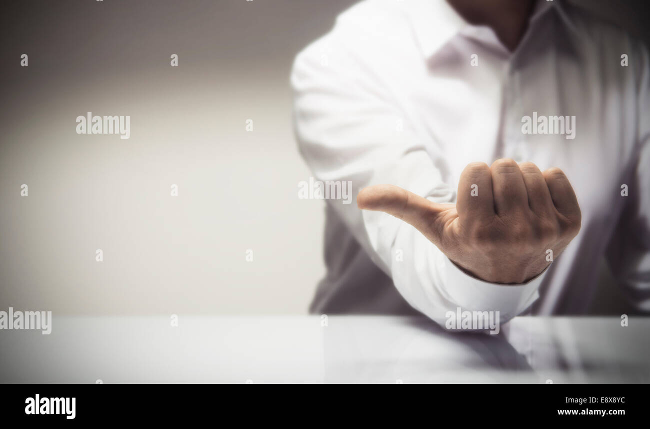 Caucasian thumb pointing left with free space for communication, focus ...