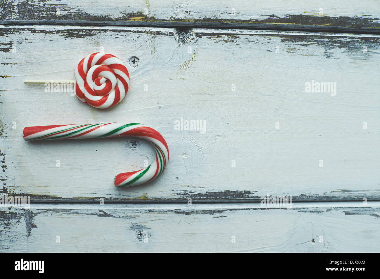 Sweet lollipop and sugar cane on white wooden background Stock Photo ...