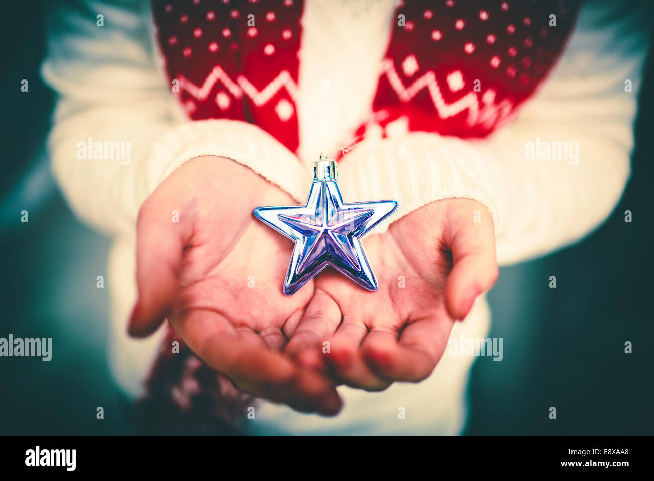 Decorative silver toy star held by a woman Stock Photo - Alamy