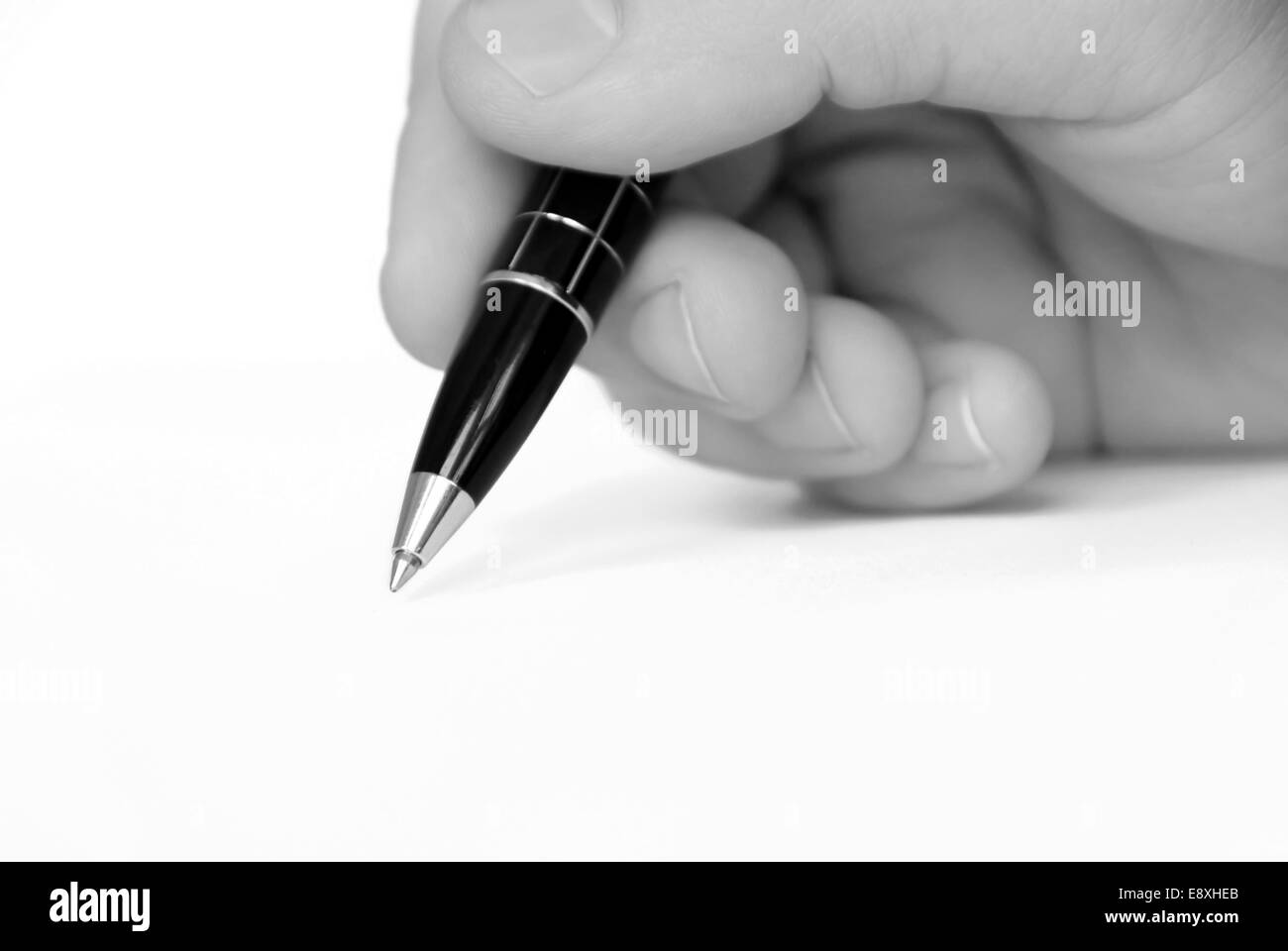 Man hand writing on white paper Stock Photo - Alamy
