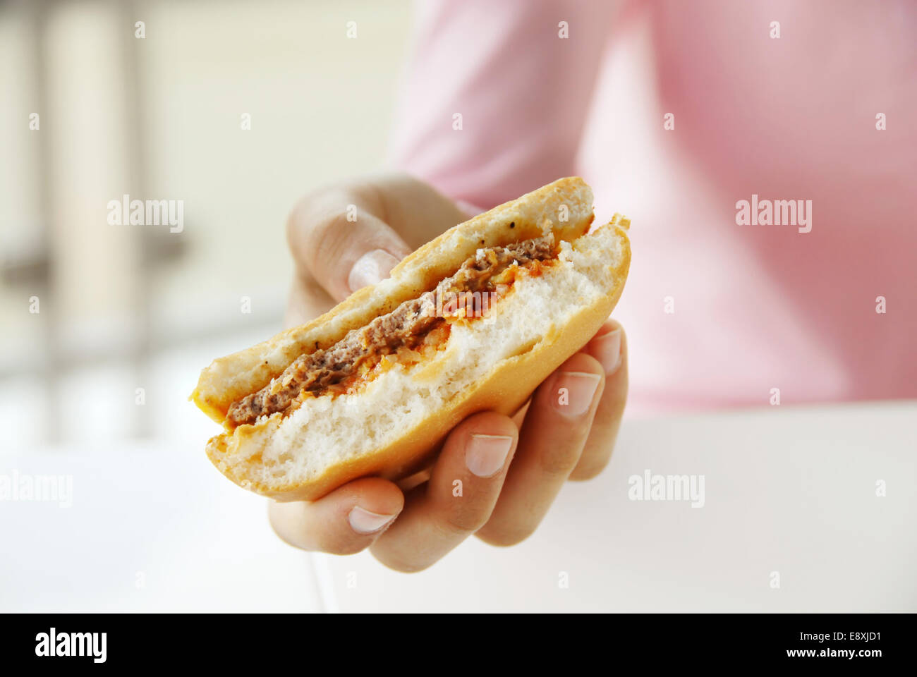 Hamburger in hand Stock Photo - Alamy
