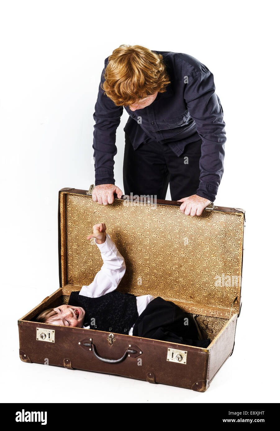 Two red-haired brothers playing with vintage suitcase Stock Photo - Alamy