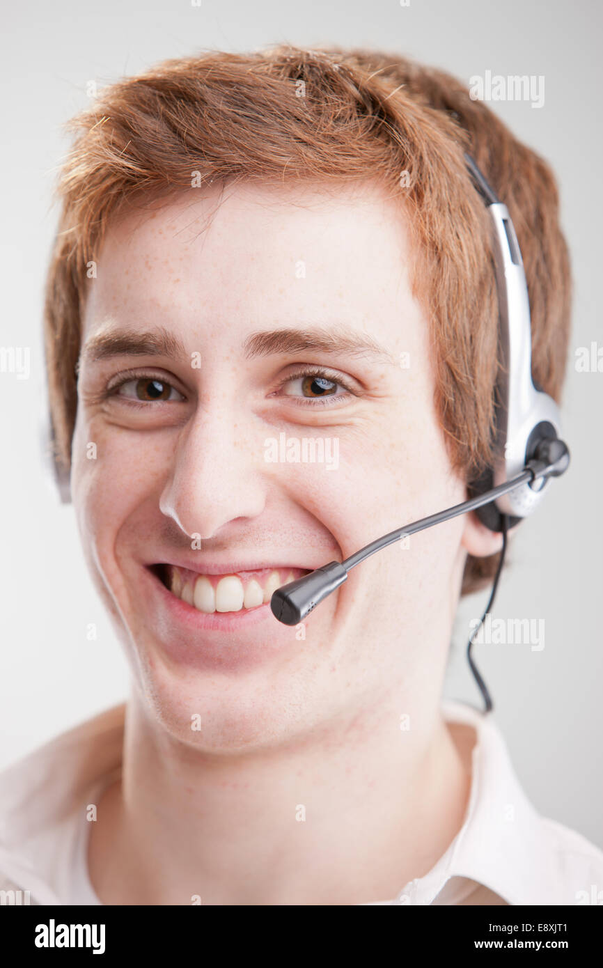 A smiling young man with red hair smiling and wearing an headset Stock ...