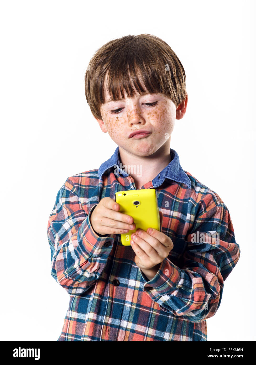 Red-haired funny boy with yellow mobile phone, preschooler Stock Photo ...