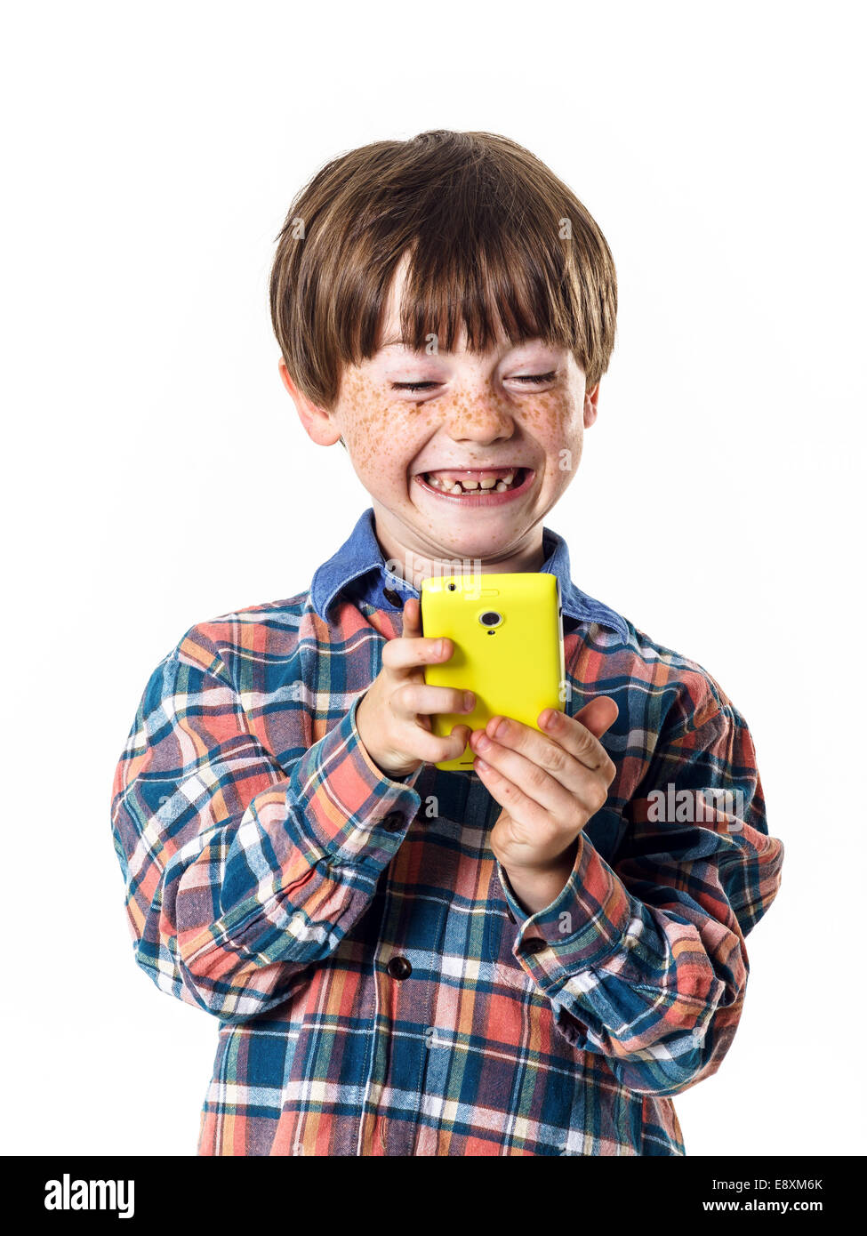 Red-haired funny boy with yellow mobile phone, preschooler Stock Photo ...