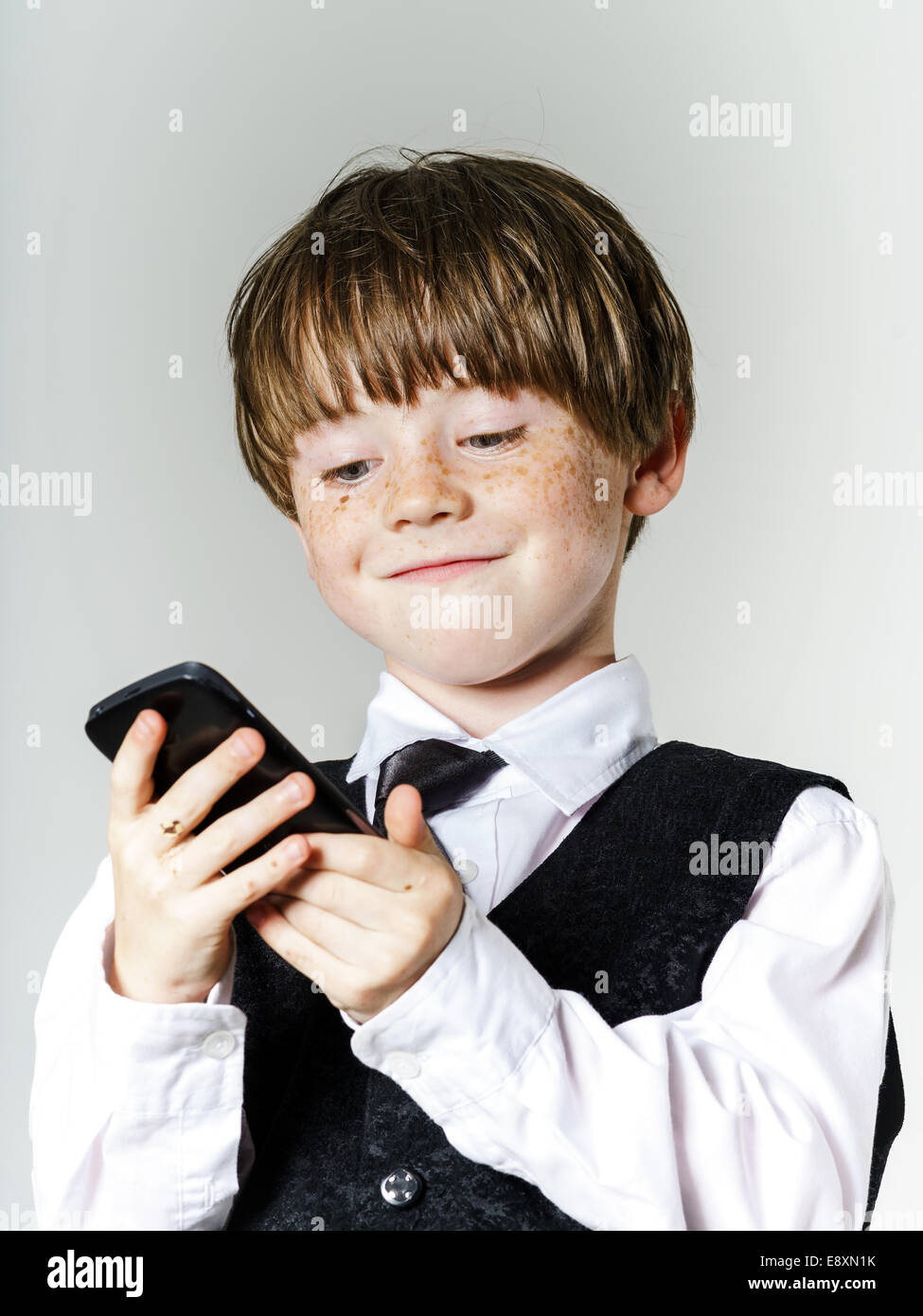 Emotional red-haired boy calling by mobile phone Stock Photo - Alamy