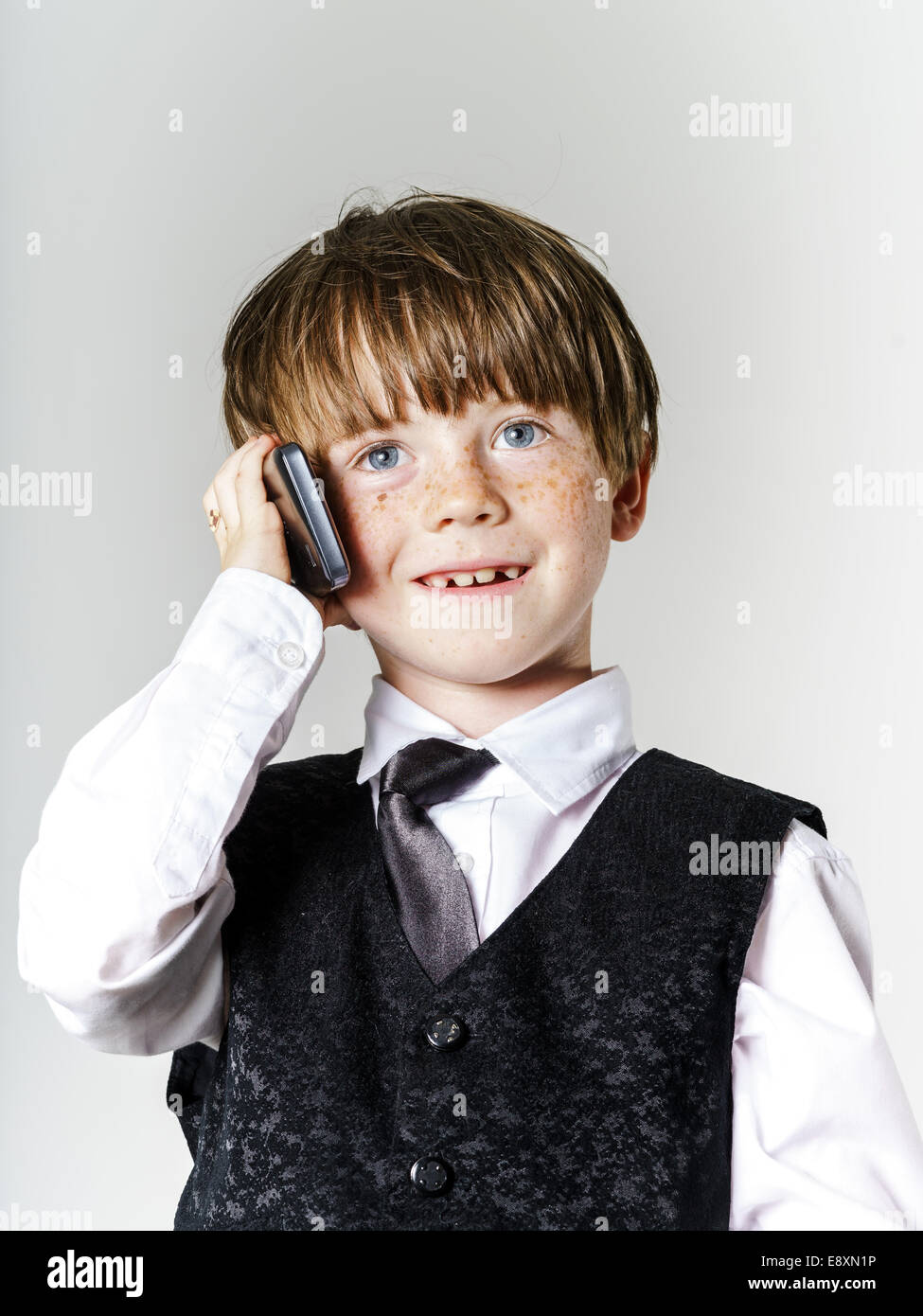 Emotional red-haired boy calling by mobile phone Stock Photo - Alamy