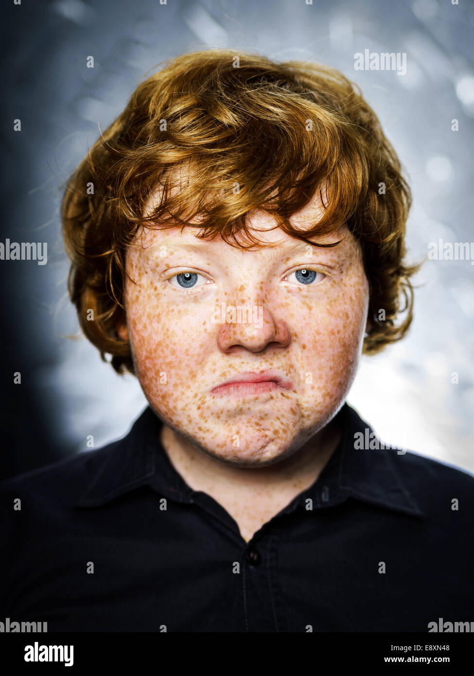 Fat freckled boy studio portrait in dark background Stock Photo - Alamy