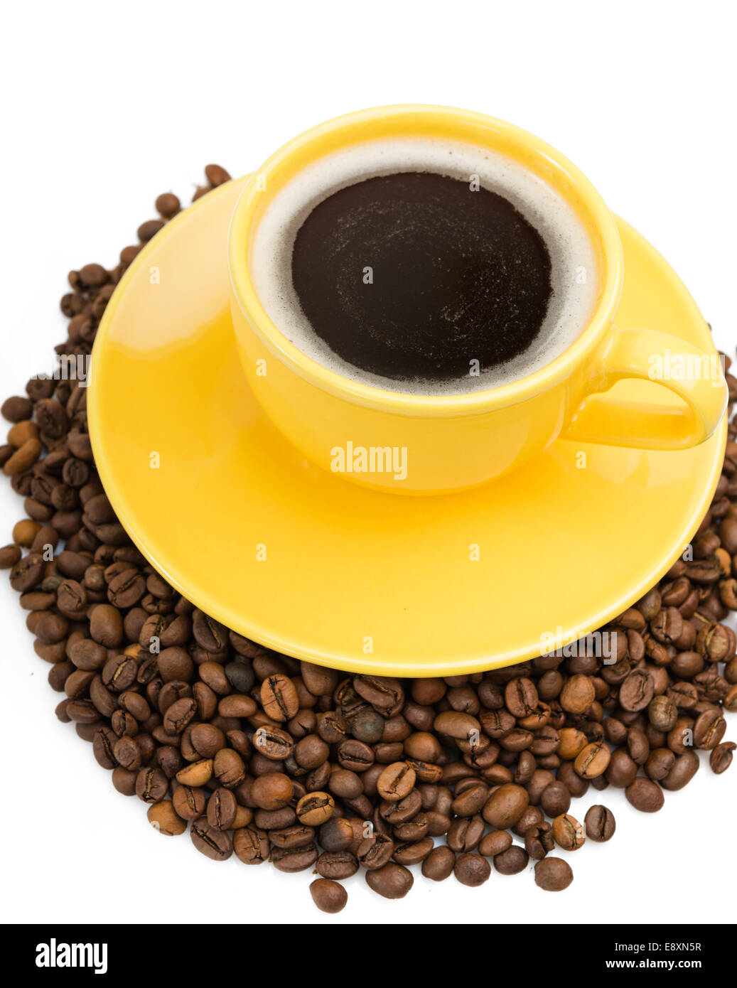 Coffee in an yellow cup and coffee beans Stock Photo - Alamy