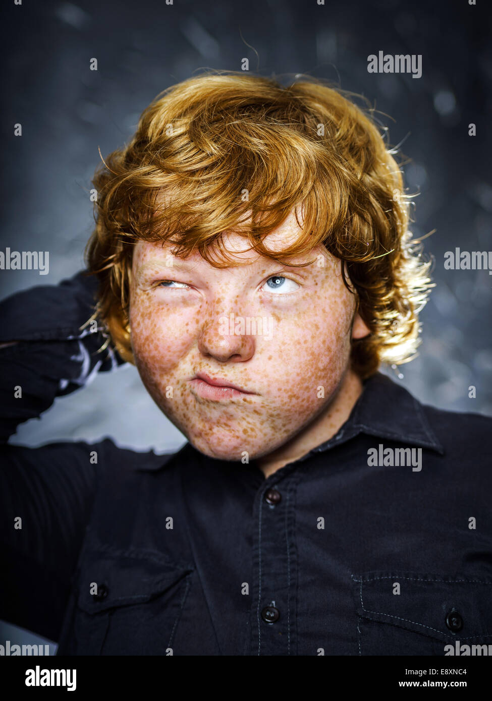 Fat freckled boy studio portrait in dark background Stock Photo - Alamy