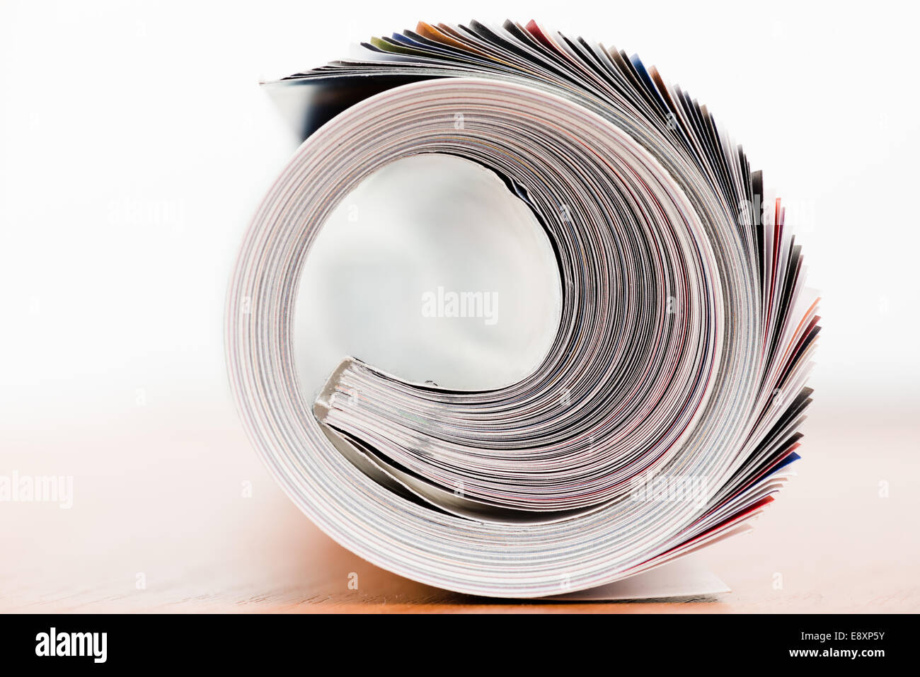 magazine roll on white background Stock Photo - Alamy