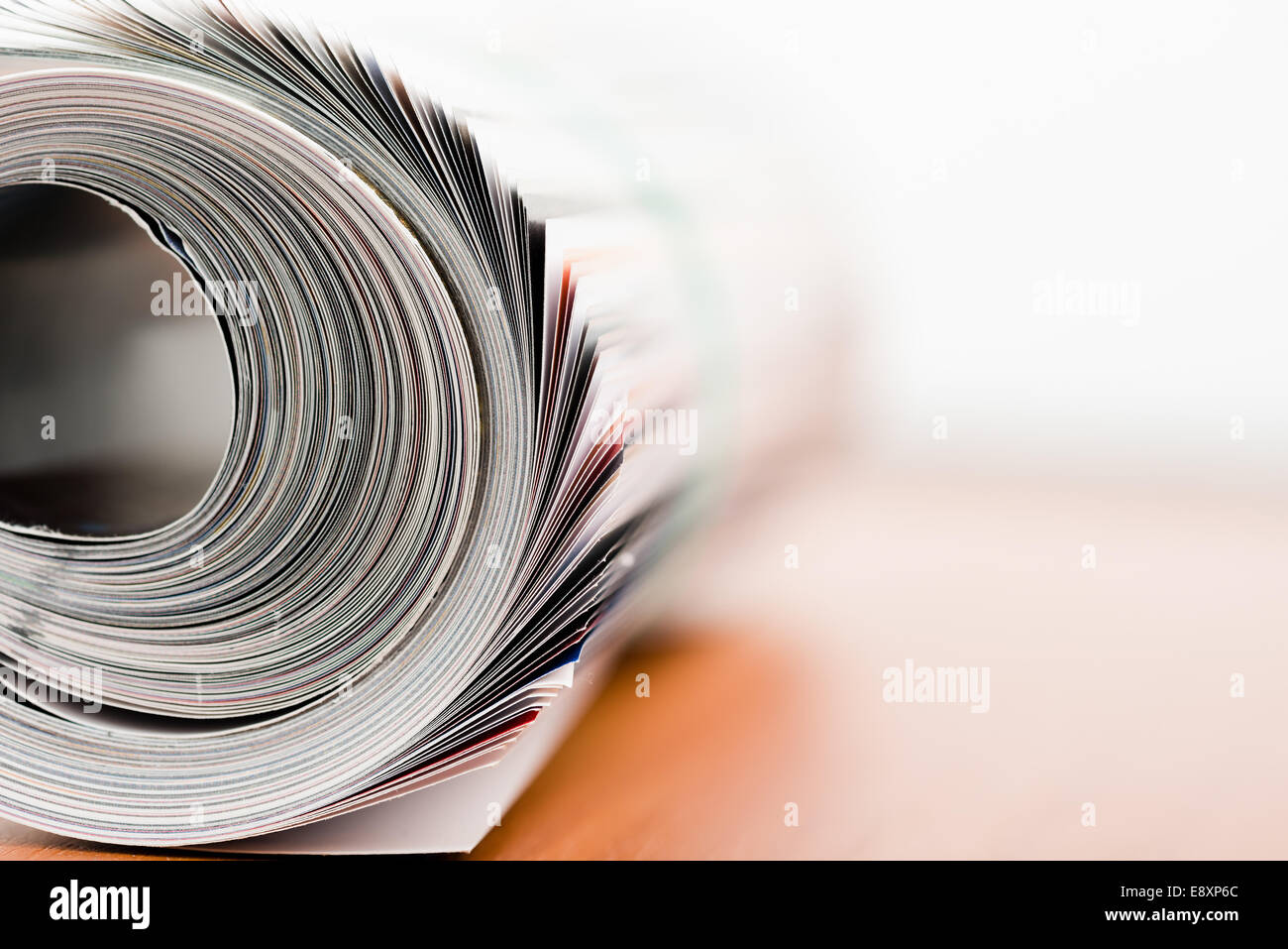 magazine roll on white background Stock Photo - Alamy