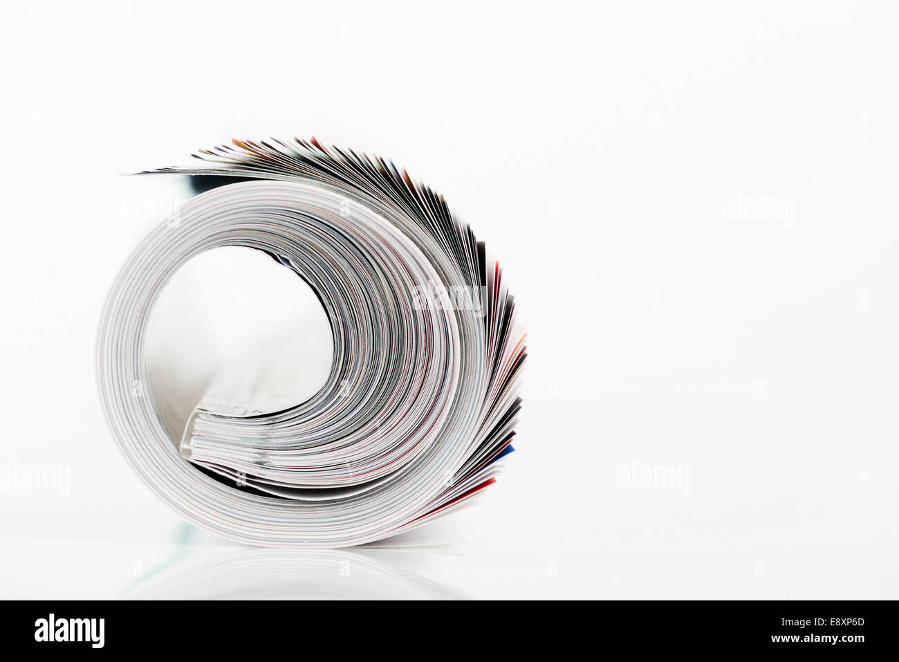 magazine roll on white background Stock Photo - Alamy