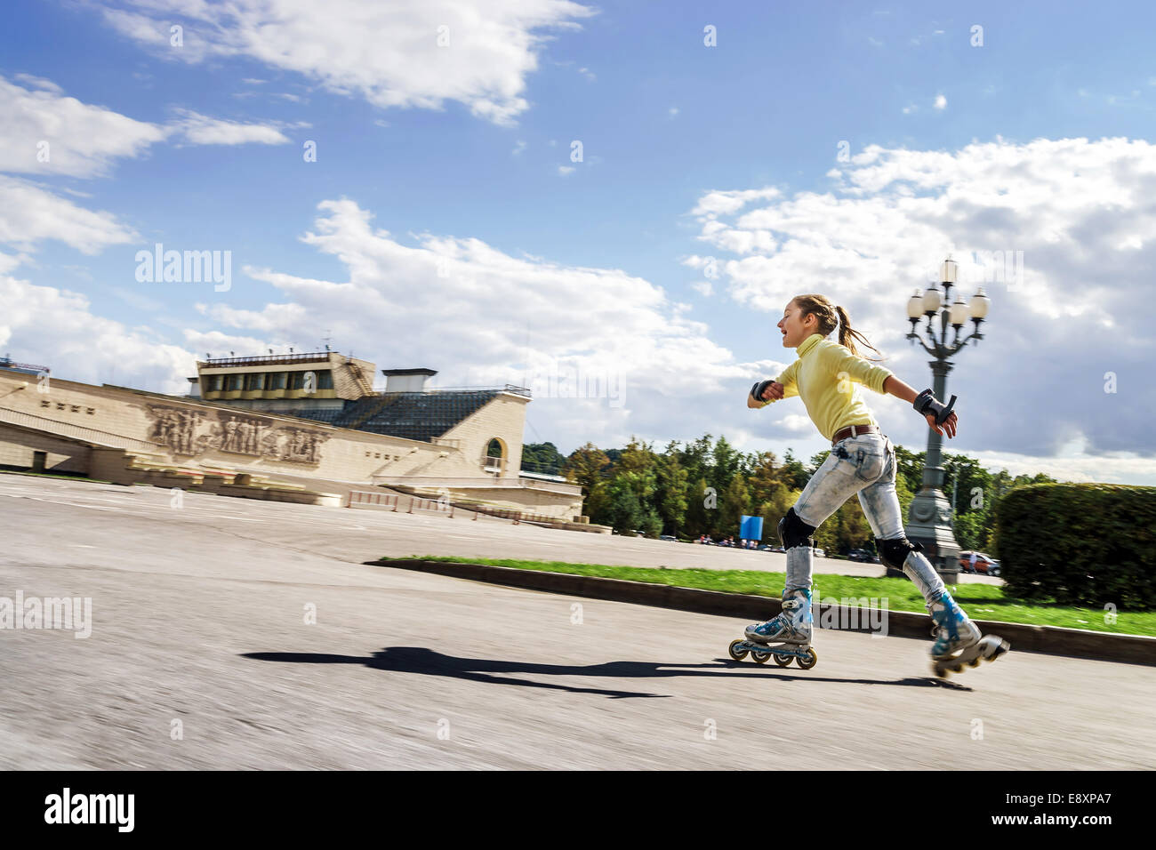 Beautiful teenage girl rollerskating in public park. Summer Stock Photo ...