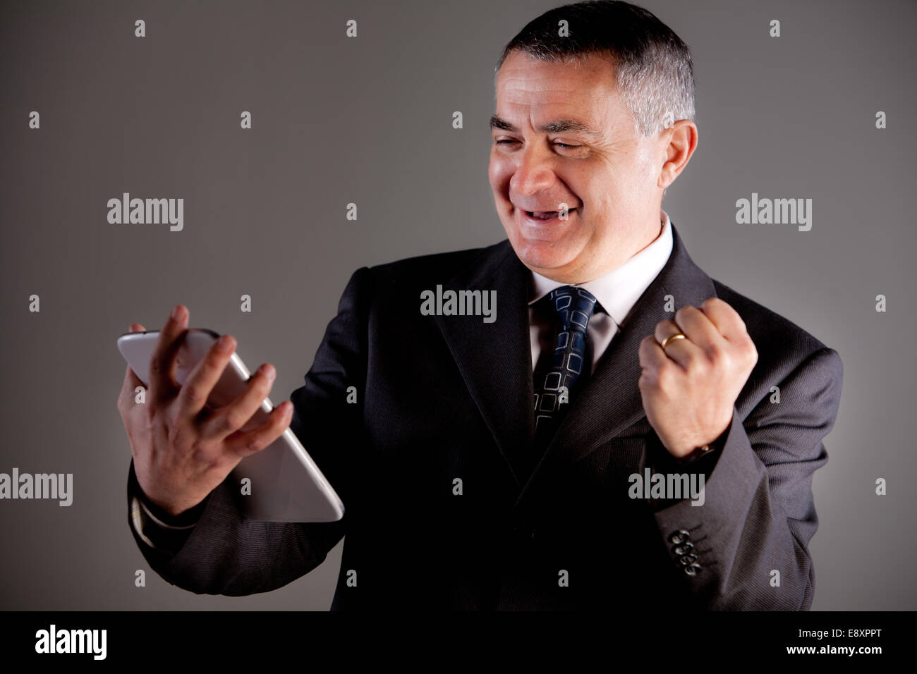 An old manager using successfully and with satisfaction a tablet Stock ...