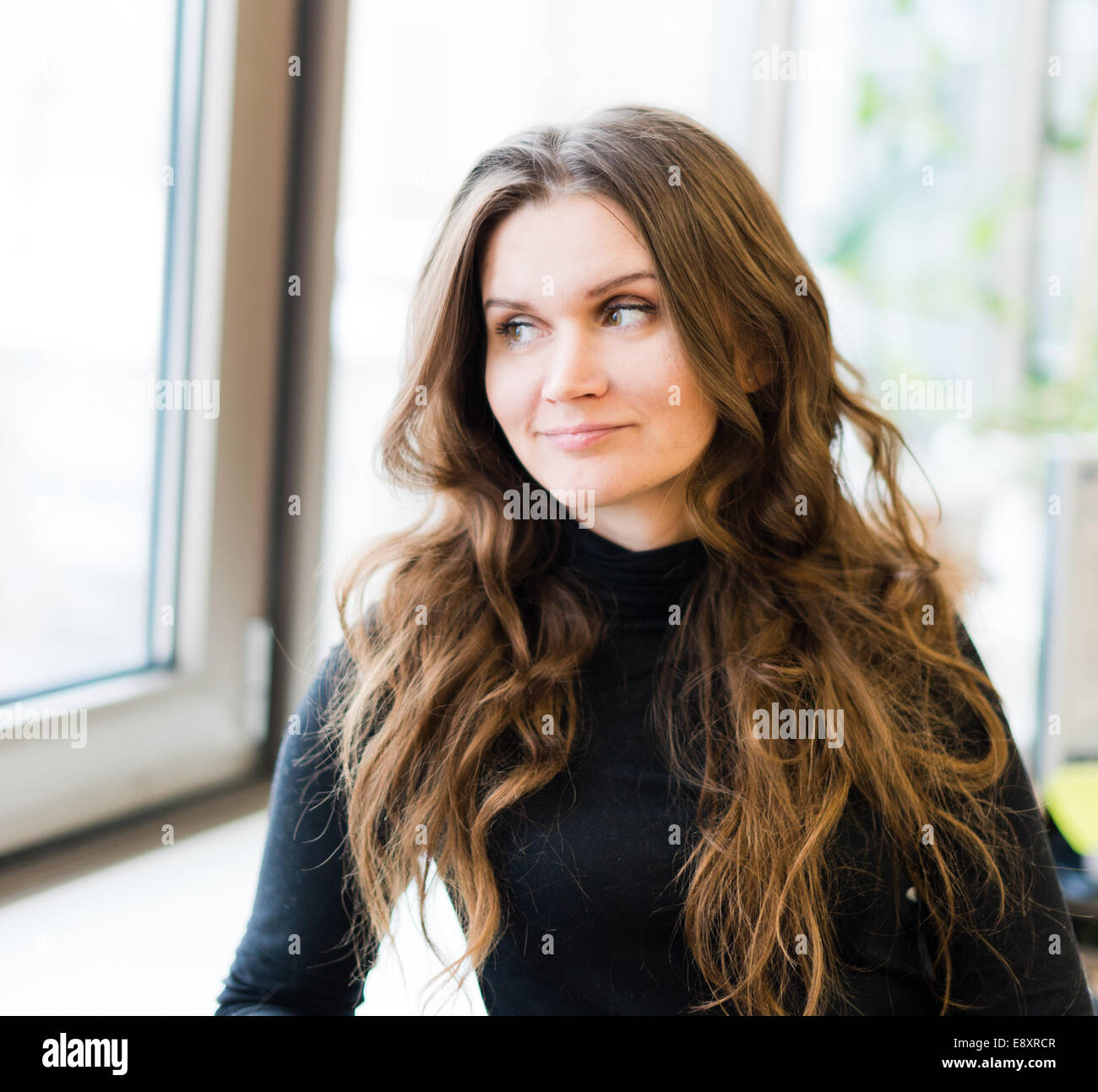 portrait of beautiful woman near window Stock Photo - Alamy