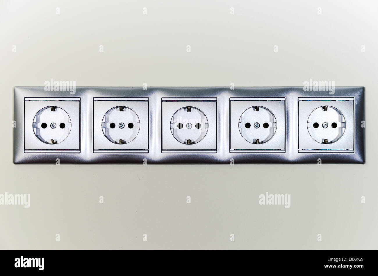 Electric sockets in line, house interior details Stock Photo - Alamy