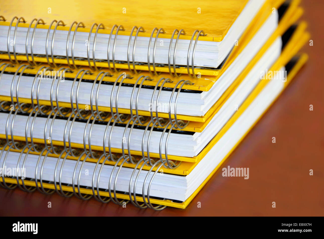 Yellow notebooks stack Stock Photo - Alamy