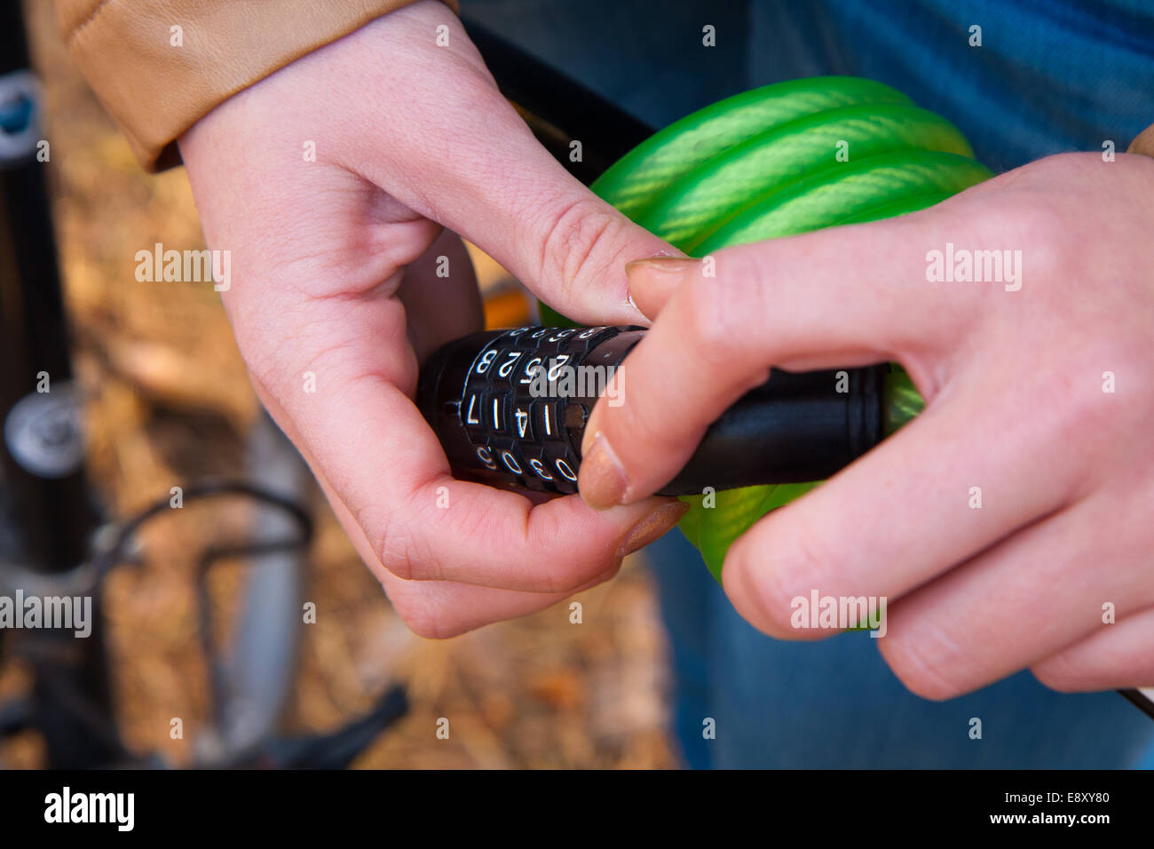 Securing a bike with an anti-theft code-lock Stock Photo - Alamy