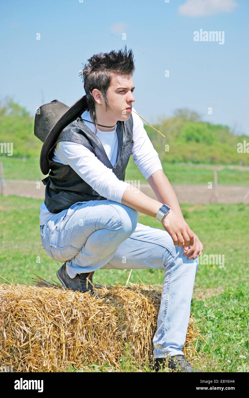 young man on hay bale Stock Photo - Alamy