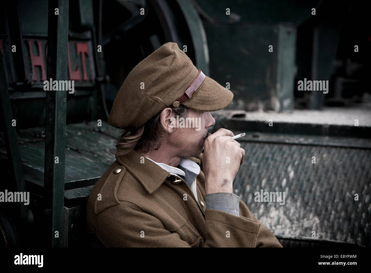 A man in WW1 period uniform sat smoking a cigarette Stock Photo - Alamy