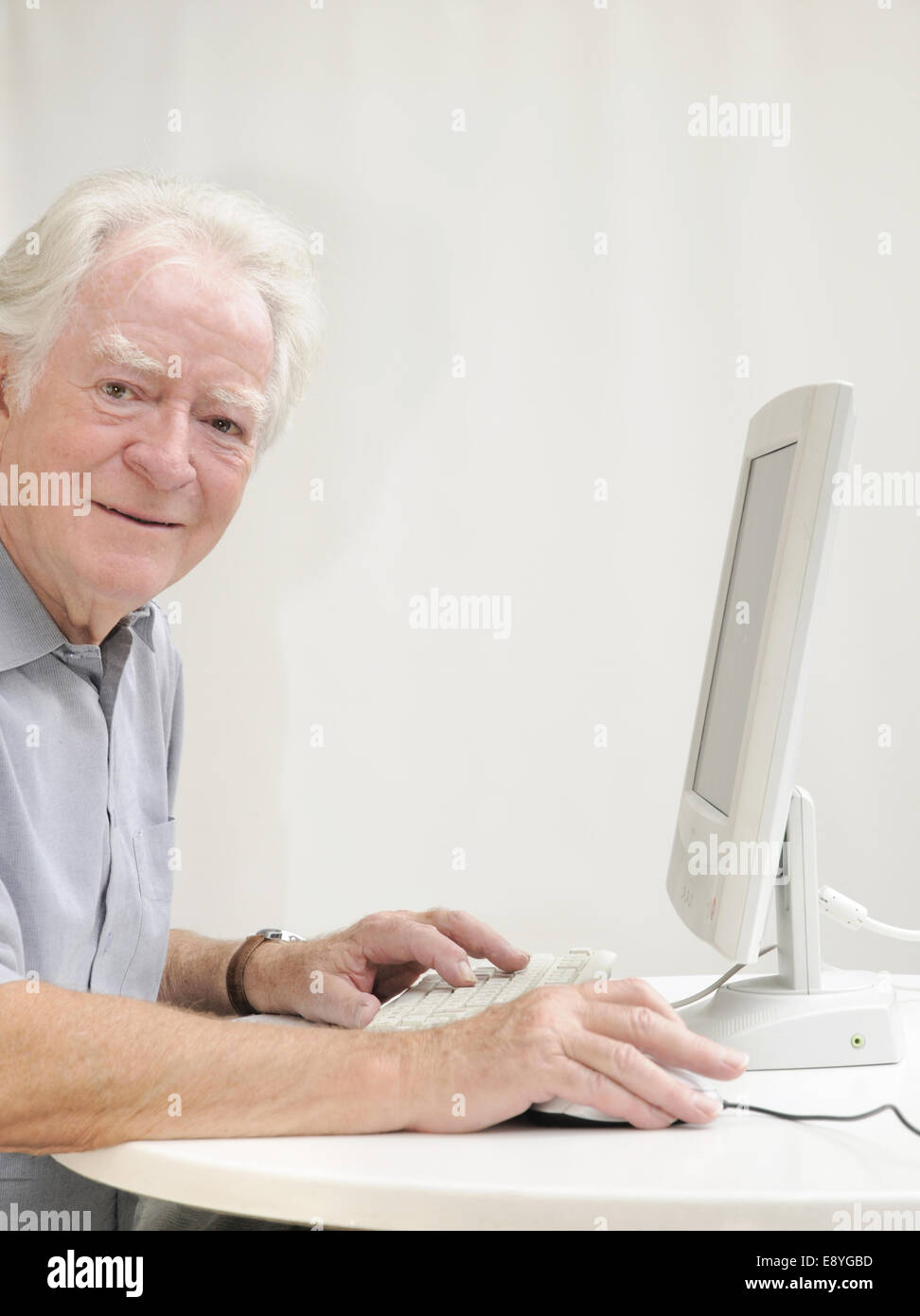 Elderly man with computer Stock Photo - Alamy