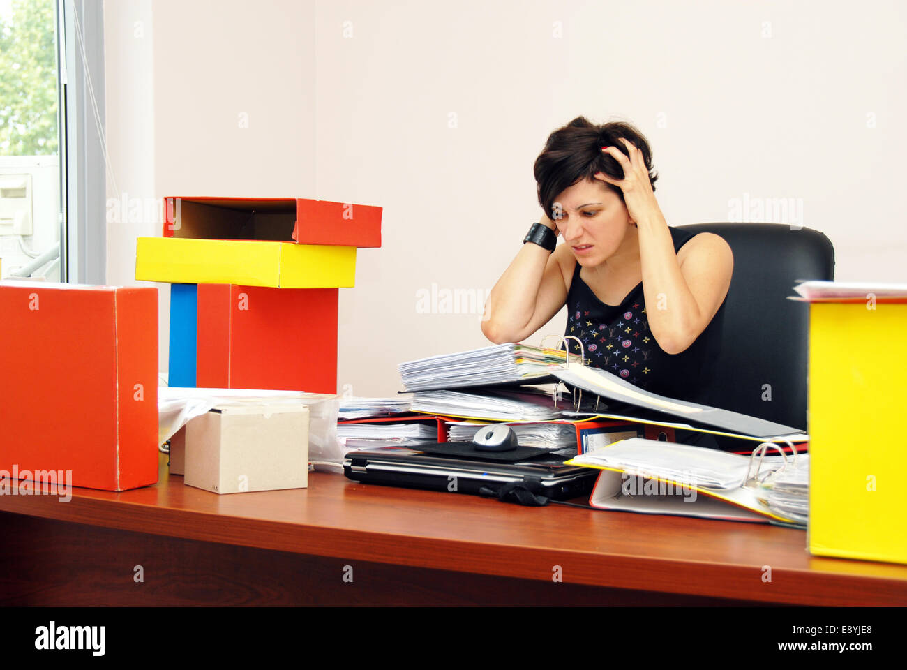 Despaired woman overloaded with work Stock Photo - Alamy
