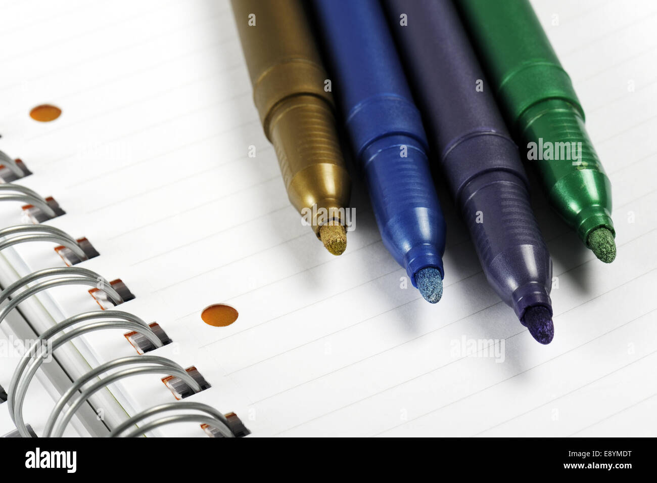 colorful markers on white book page Stock Photo - Alamy